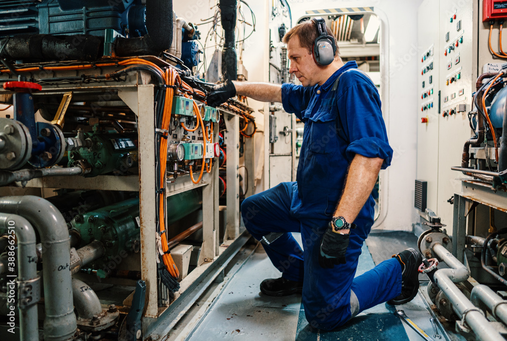 Marine engineer officer controlling vessel engines and propulsion in ...
