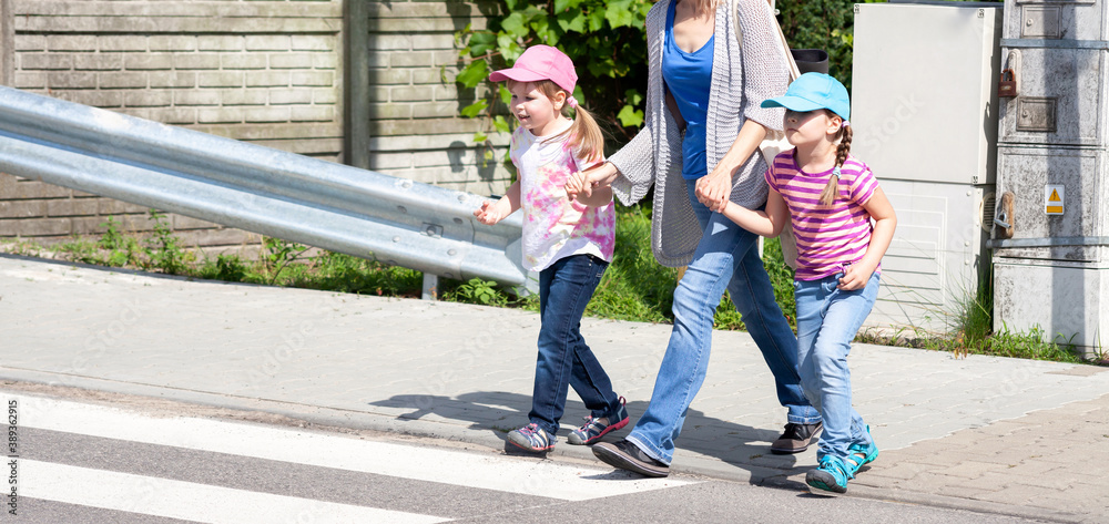 Two little girls, children crossing the street on the zebra crossing ...