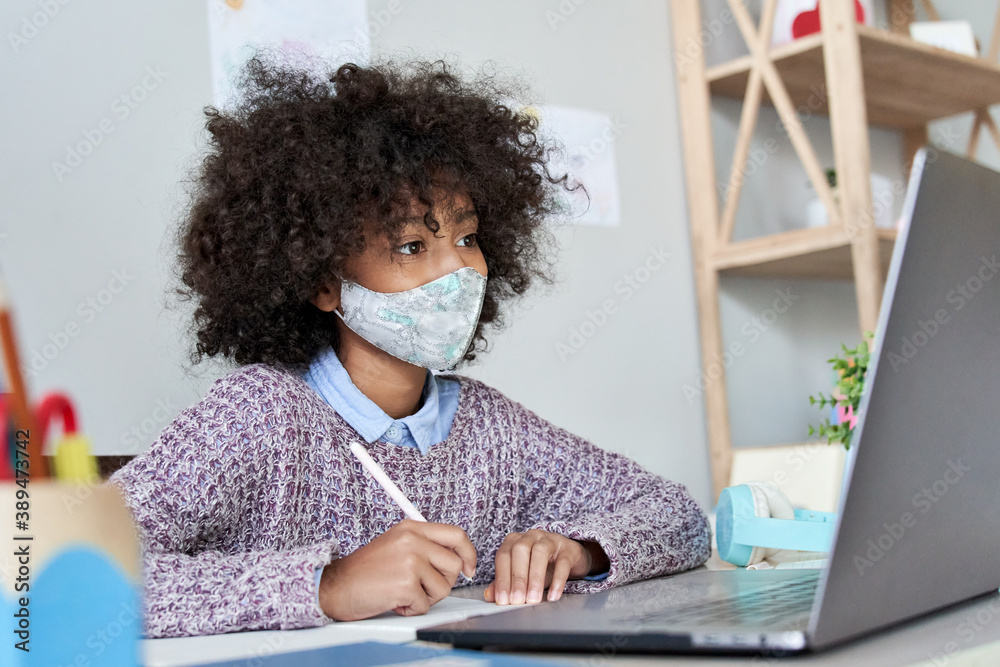 African american school kid child girl wearing face mask watching ...