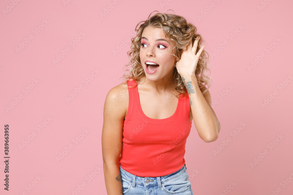 Excited curious young blonde woman 20s wearing basic casual tank top ...