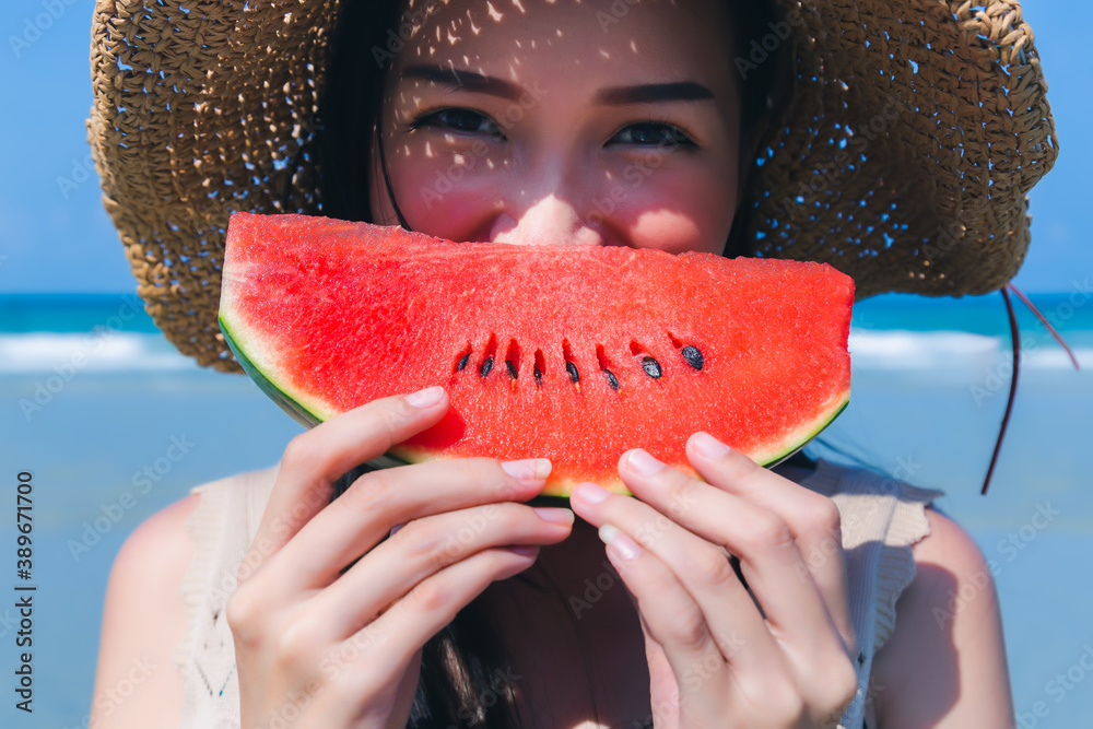 Happy beauty woman enjoy eating slice of watermelon on tropical beach ...
