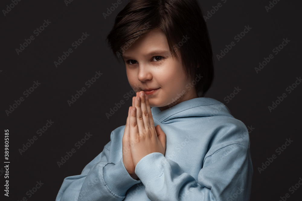 Foto de Stock Portrait of Cute boy 10-12 years old keeping palms together and praying. Human ...