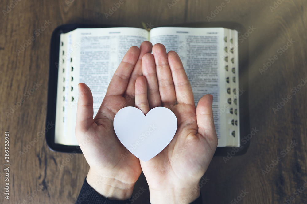 Hands female prayer to Load with broken heart in hands on the bible ...