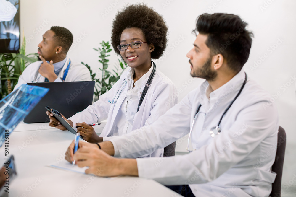 Cropped image of team of multiethnic doctors, looking doctor speech at ...