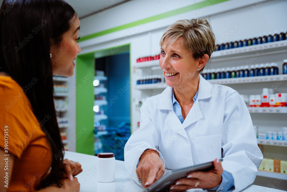 Foto Senior pharmacist explaining medication guide to mixed race client ...