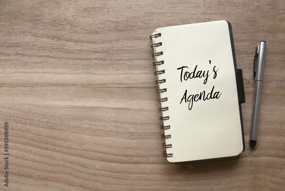 Top view of pen and notebook written with Today's Agenda on wooden ...