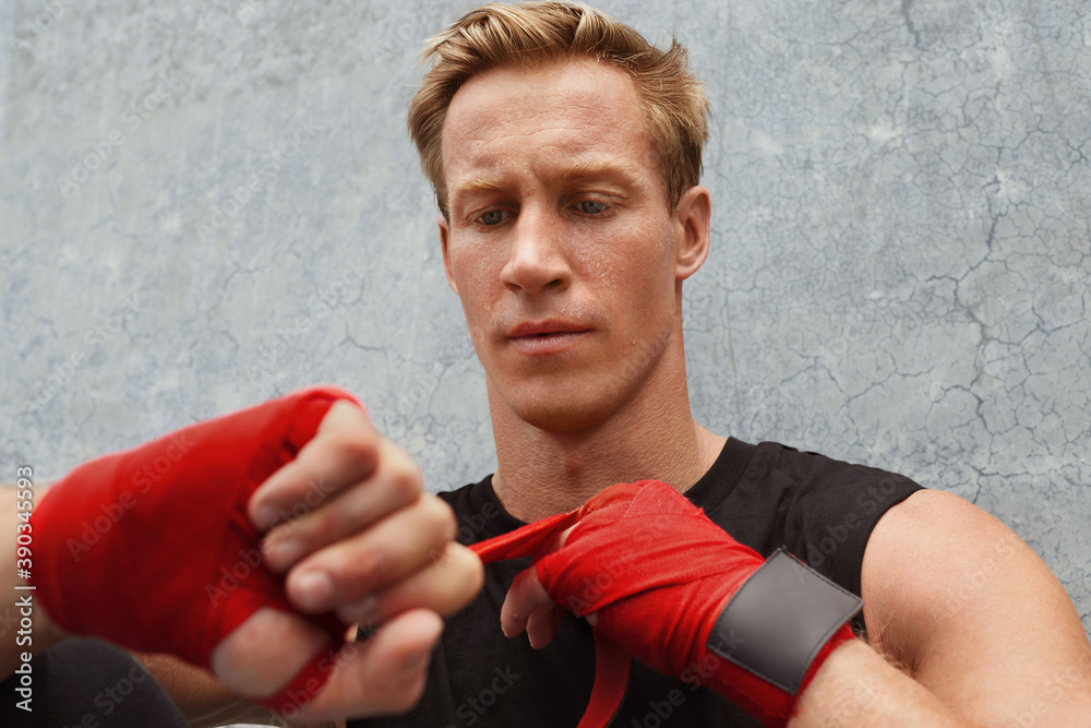 Photo Stock Young Man Wrapping Hand And Wrist With Boxing Tape Against ...