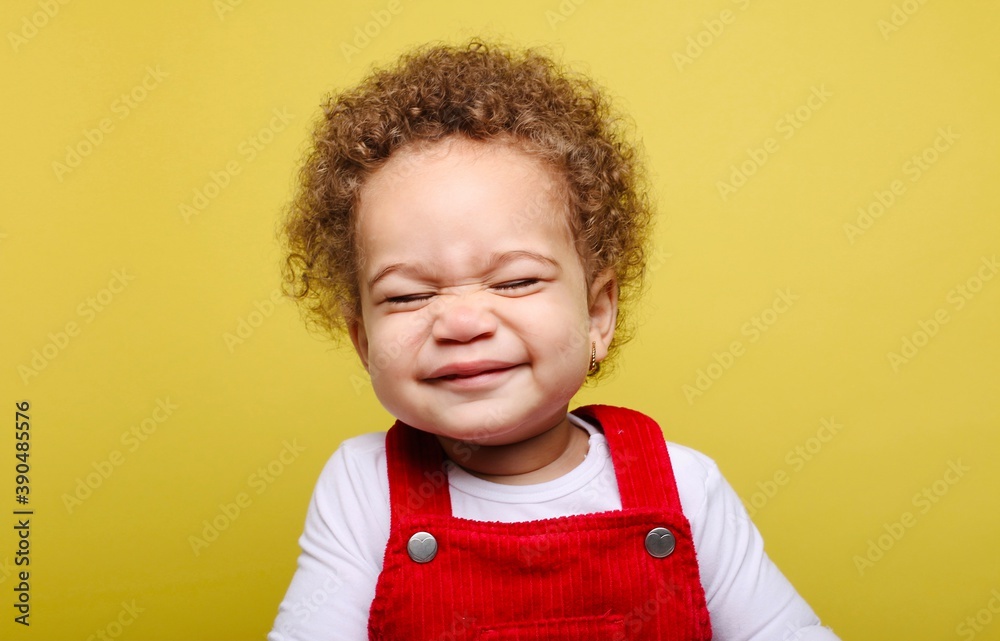 Beautiful little girl in front of a background Stock Photo | Adobe Stock