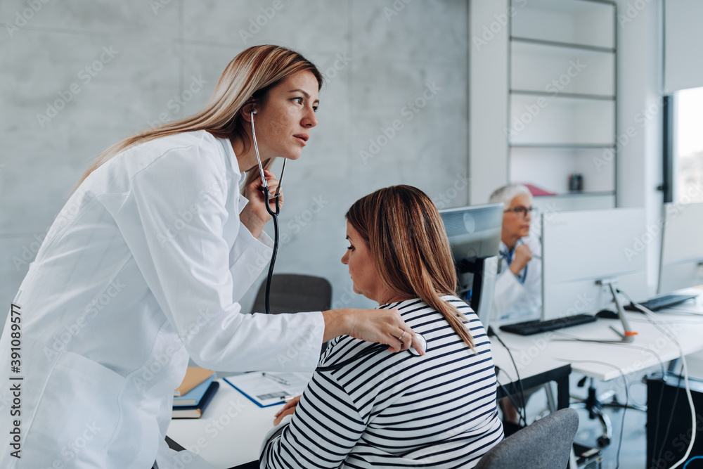 Female doctor examining diabetic woman in hospital. Stock Photo | Adobe ...