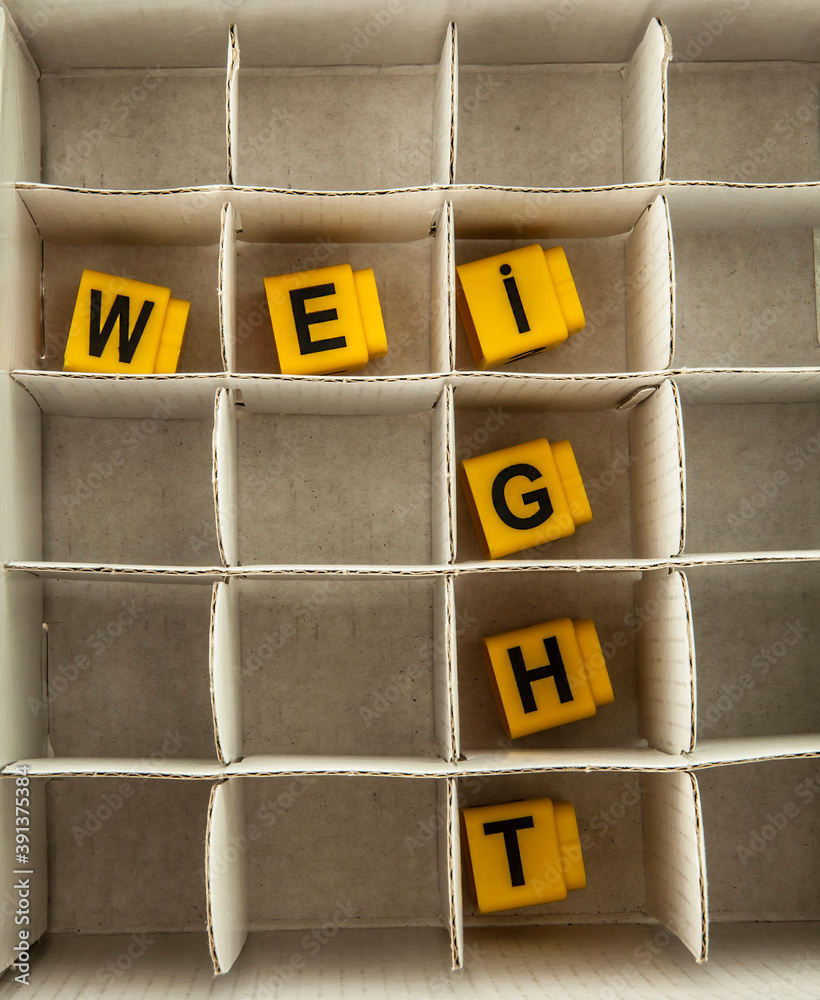 closeup weight wording isolated on white box cell background Yellow ...