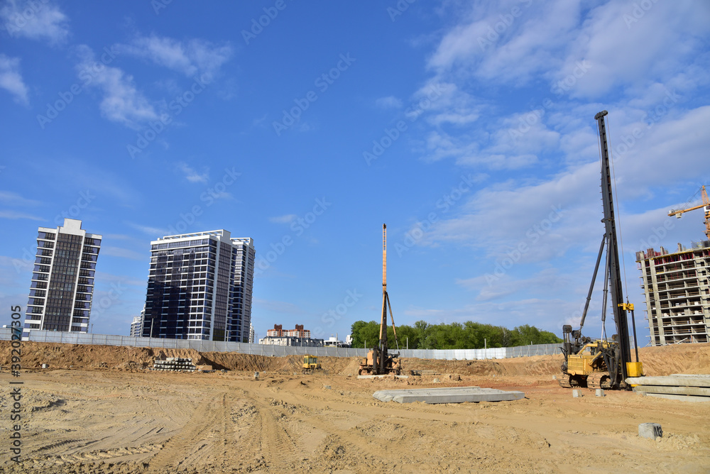 Construction site with machinery for deep foundation piling. Vibrating ...