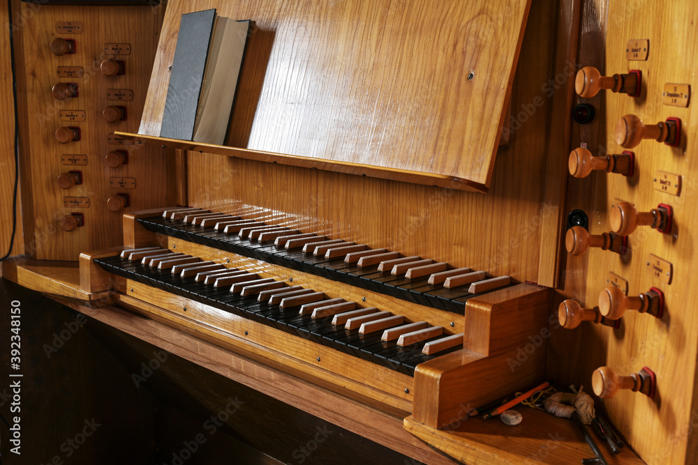 Pipe organ console with two keyboards also called manuals and wooden ...