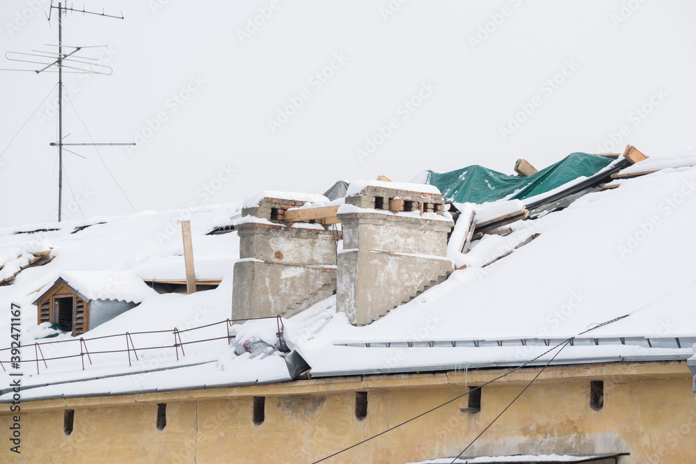 Roof repairs of an apartment building. The roof collapsed under the ...