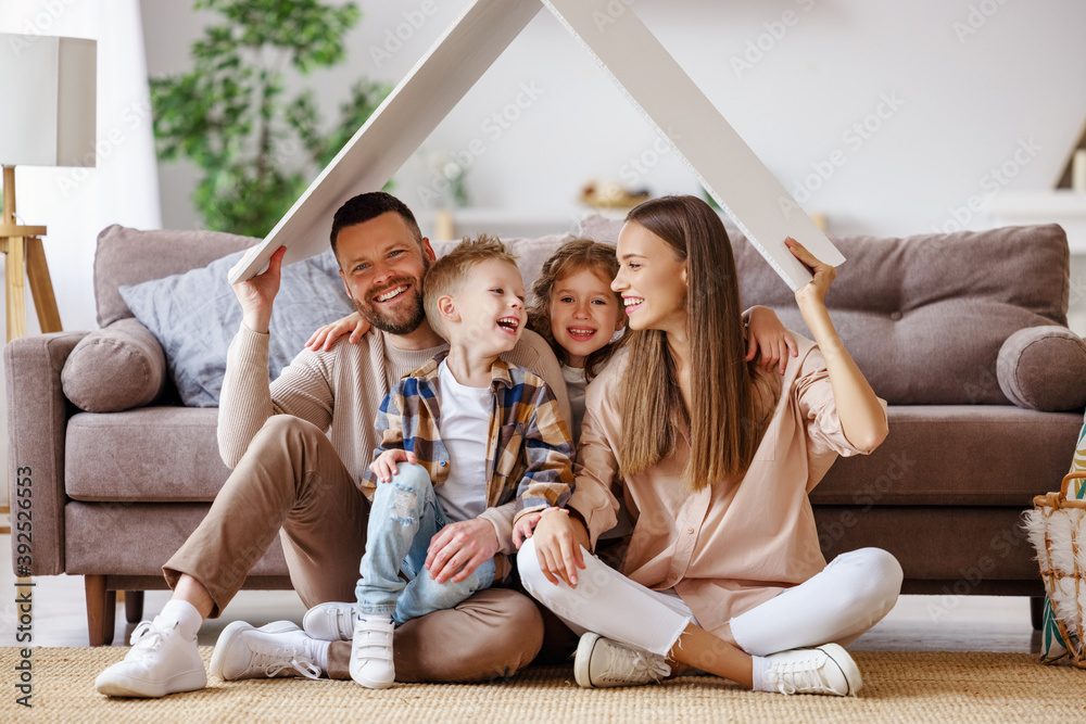 concept housing young family. mother father and children under fake ...