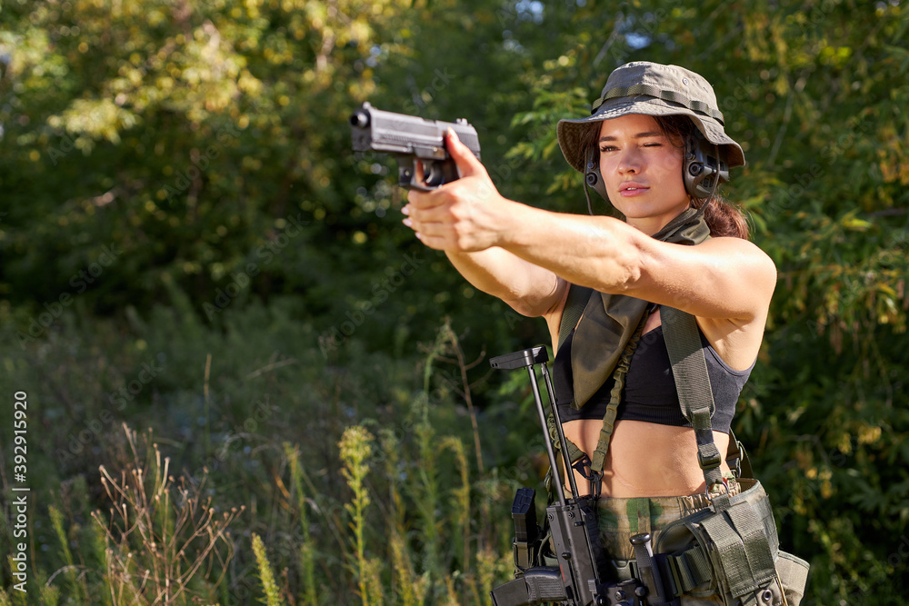 young sexy slender caucasian woman soldier shooting with rifle machine ...