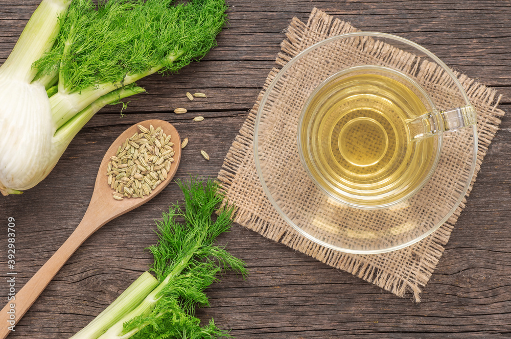 Herbal infusion fennel tea in glass cup or mug with dried fennel seeds ...