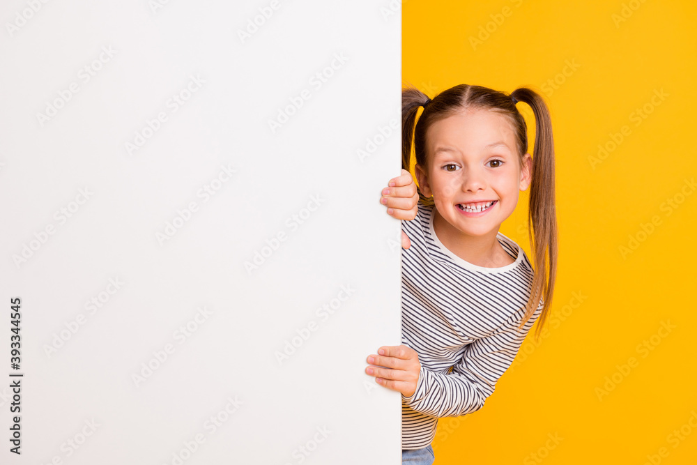 Photo of young happy smiling little girl child kid stand behind white ...