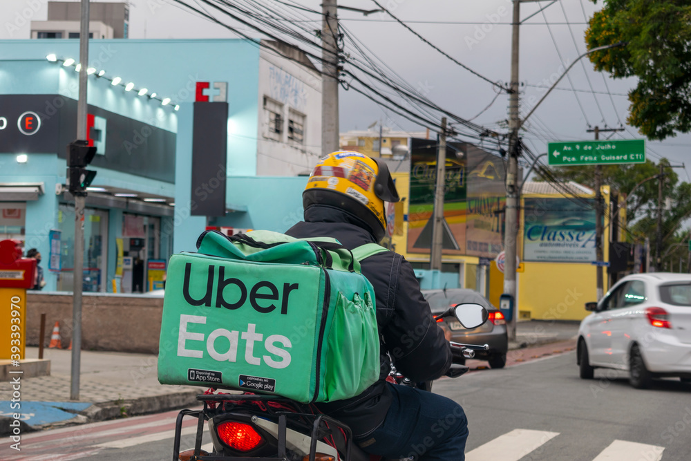 Uber Eats rider delivers food to city customers during the covid-19 ...
