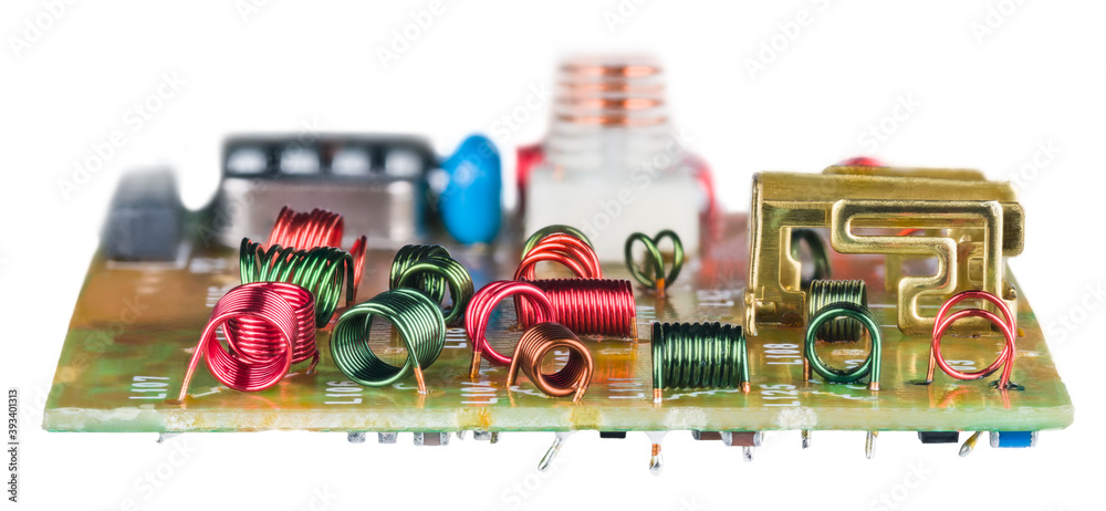 Colored wire winding of air core coils in circuit board on white ...