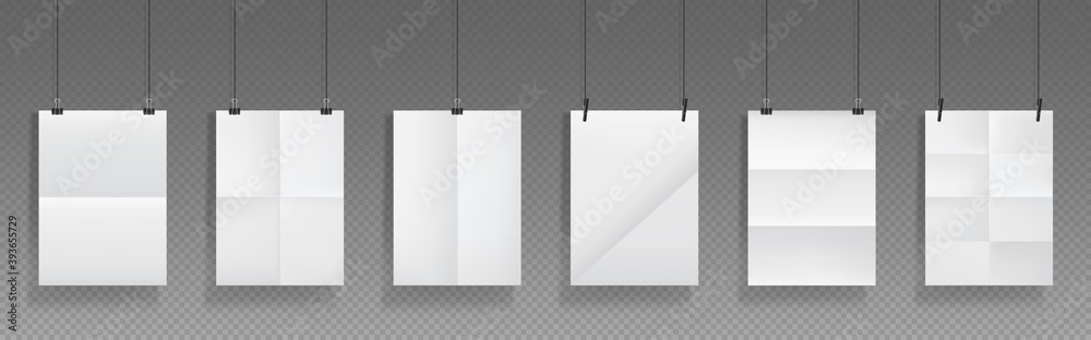Folded blank posters hang with binder clips, white paper sheets with ...