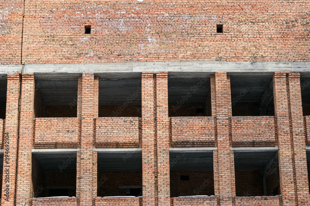 Brick building with non-glazed window openings. Concrete floors. White ...