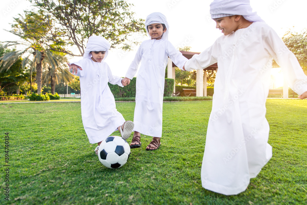 Children playing together in Dubai in the park. Group of kids wearing ...