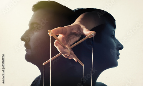 Multiple exposure with man and woman silhouette and controlling hand ...