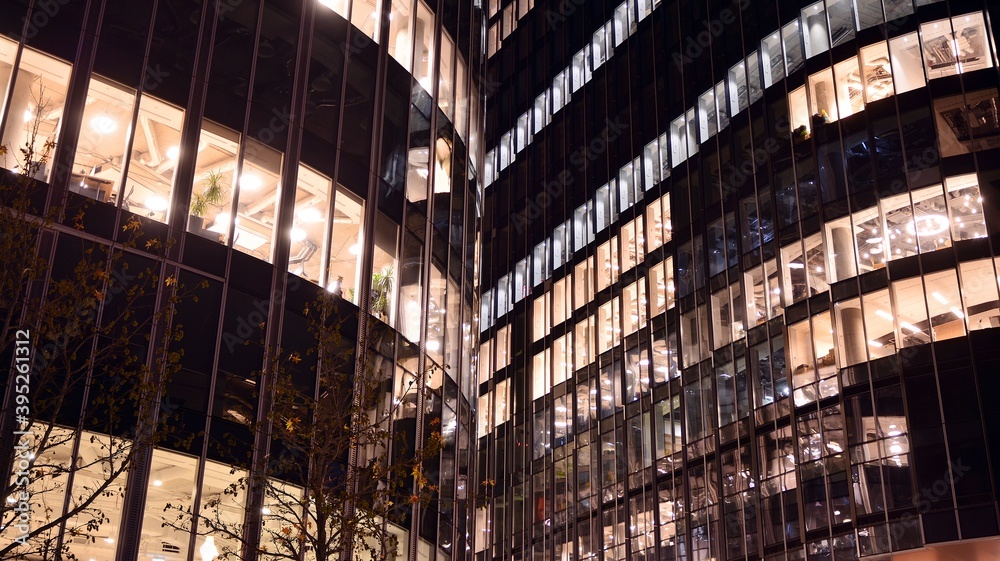 Pattern of office buildings windows illuminated at night. Lighting with ...