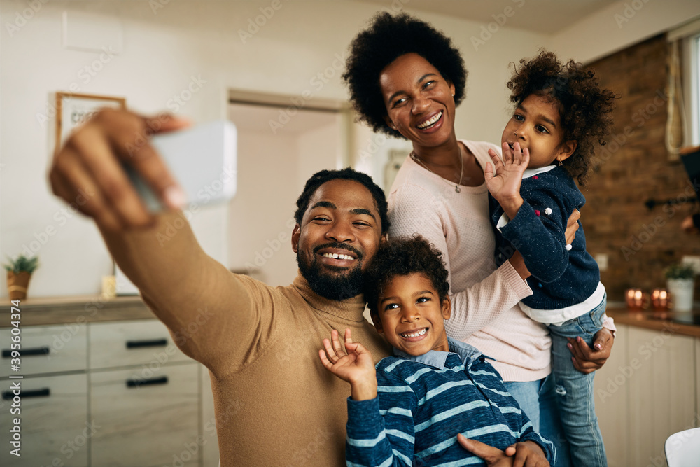 Happy black parents with kids making video call over smart phone at ...