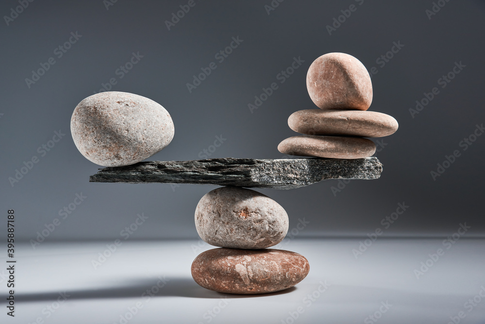 Balancing pyramid of sea pebbles on a gray background, the concept of ...