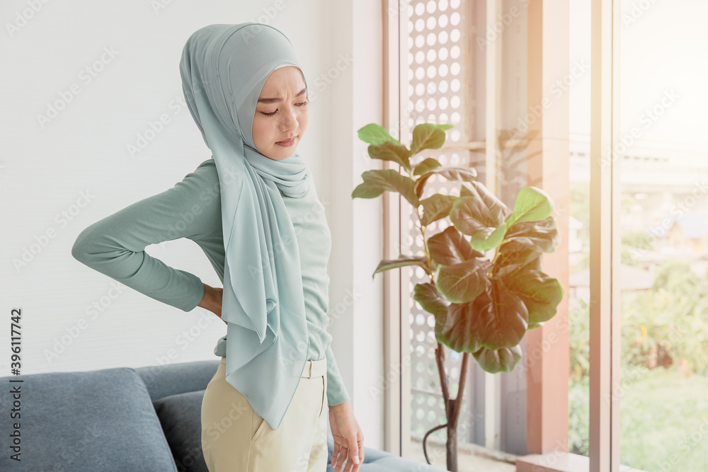 Fotografie Arab Islam Women back pain from office working or Kidney ...