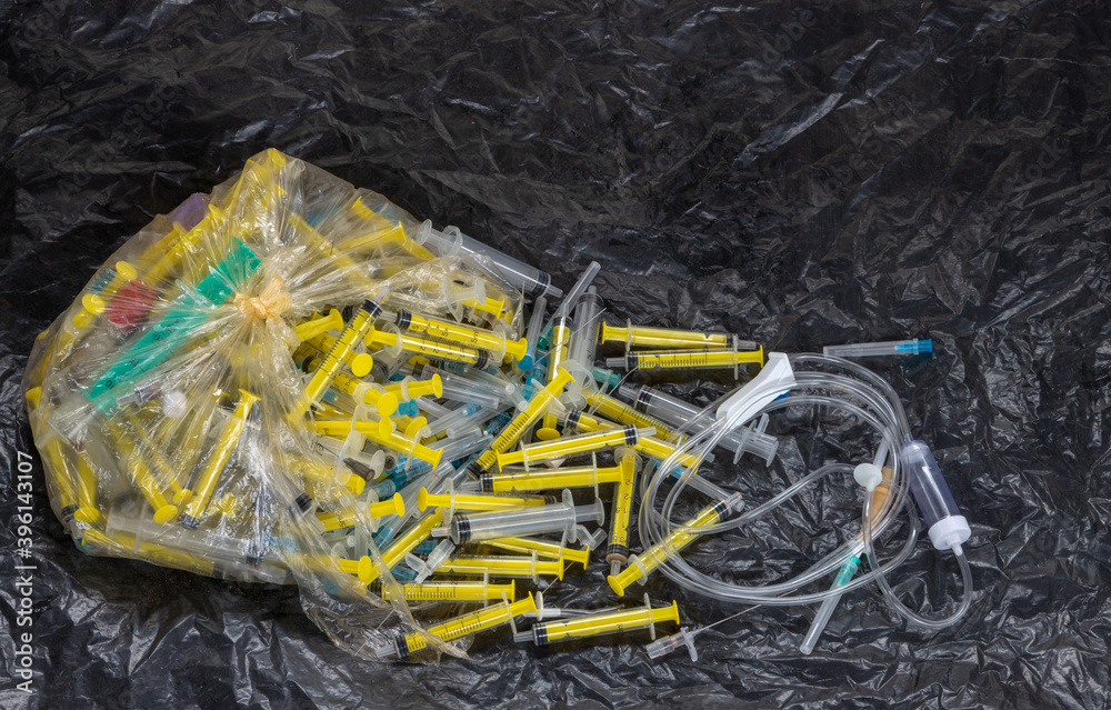 disposal of medical waste used disposable syringes lie in a large pile ...