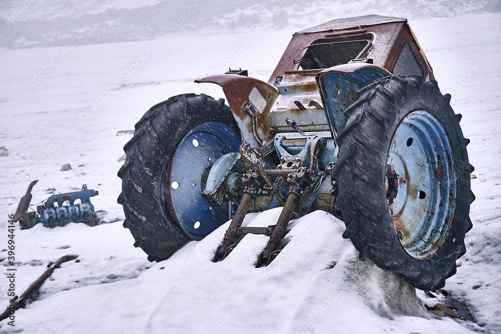Disassembled parts of the old tractor as rubbish and pollution on a ...