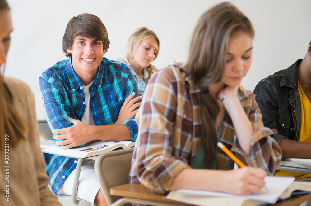 Teenage student smiling in classroom Stock Photo | Adobe Stock