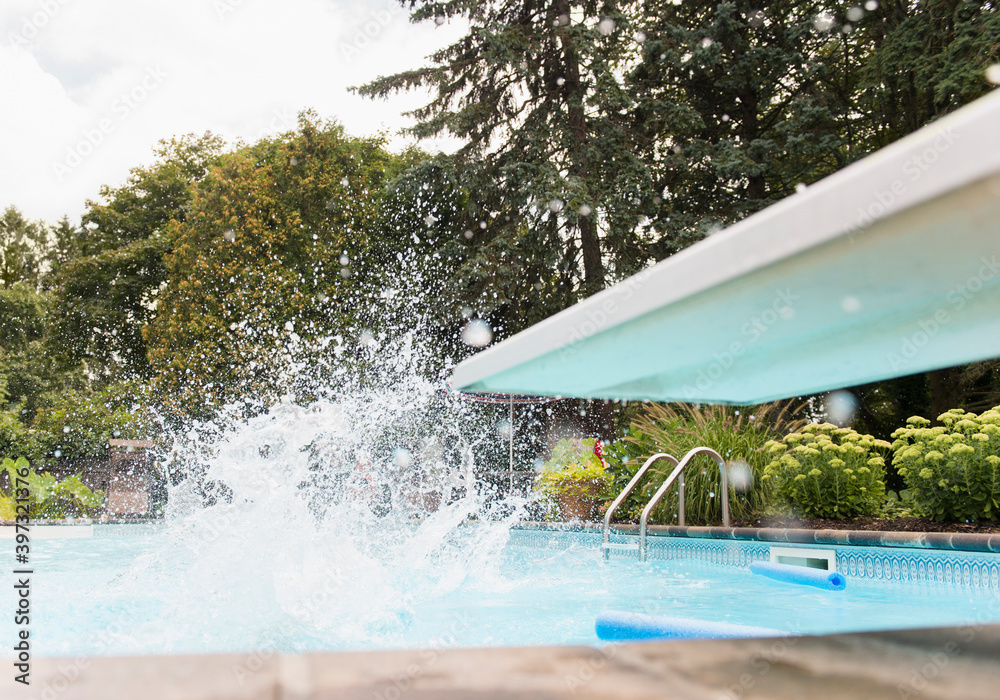 Splashing water near diving board in swimming pool Stock Photo | Adobe ...