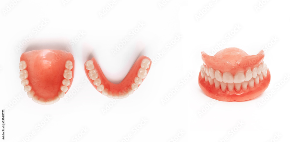 Full removable plastic denture of the jaws. Set of dentures on a white ...