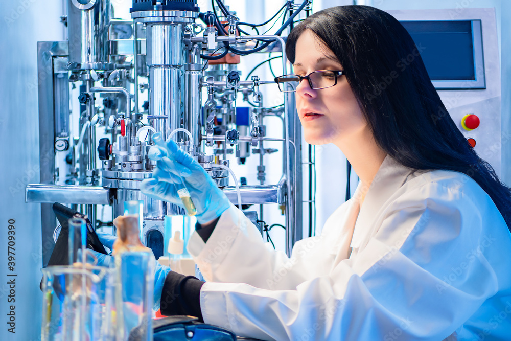 Foto Laboratory assistant works next to the bioreactor. Concept - woman ...