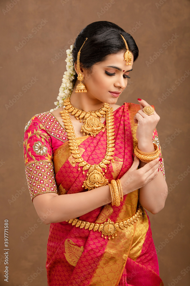 Beautiful Indian young Hindu Bride against brown background in studio ...