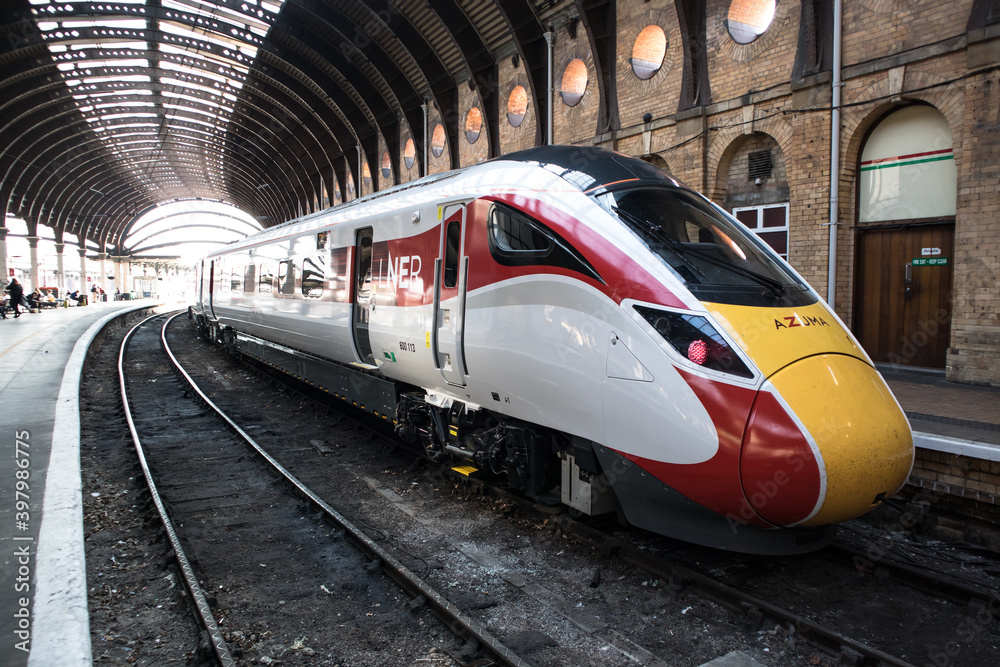 LNER Azuma train on a platform waiting to depart. Empty Platform inside ...