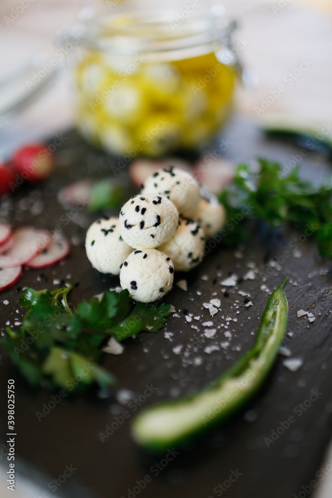 Labneh, middle-eastern yoghurt, with black sesame seeds, herbs, spices ...