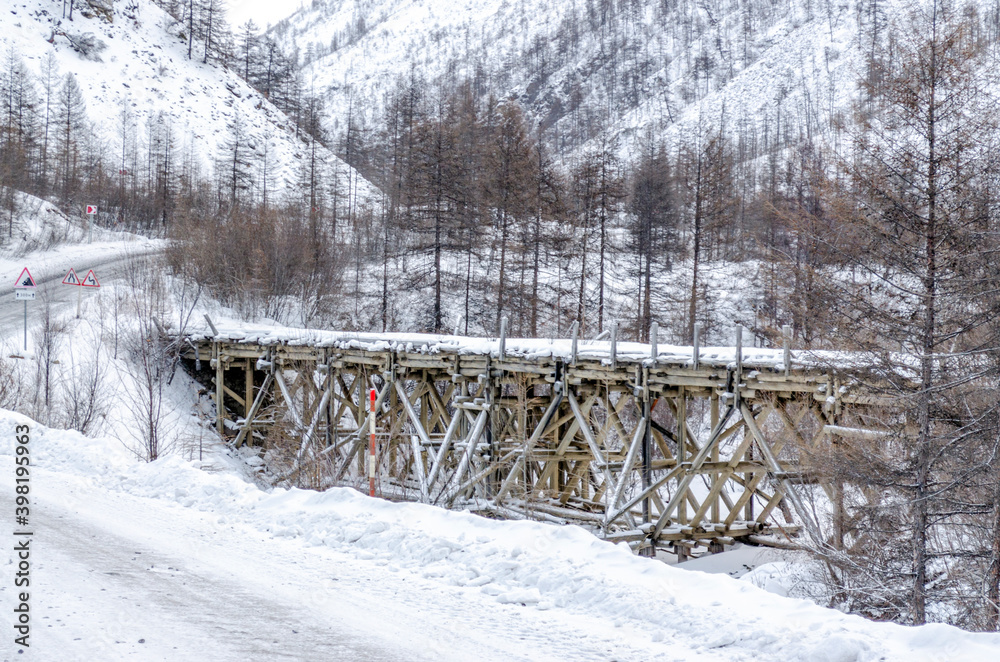 Wooden bridge, snowy mountains, gulag, Kolyma, the R504 Kolyma Highway ...