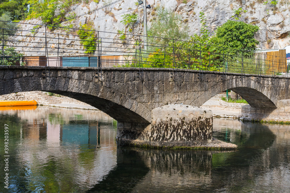 View of the stone arch bridge in the town of Blagaj. Bosnia and ...