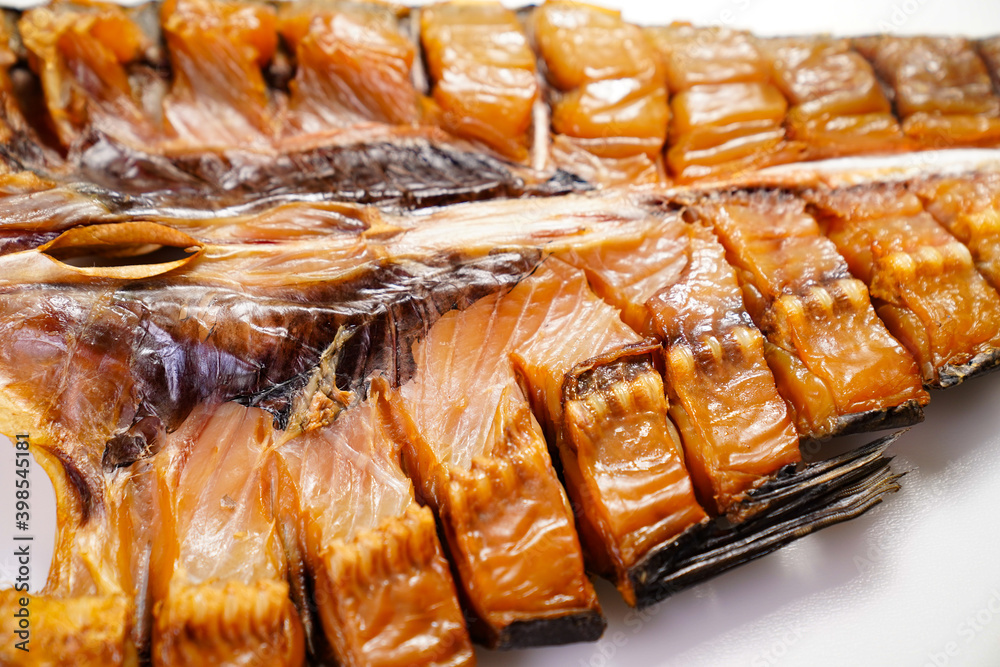 cold-smoked silver carp fish on a white background. salty snacks to ...