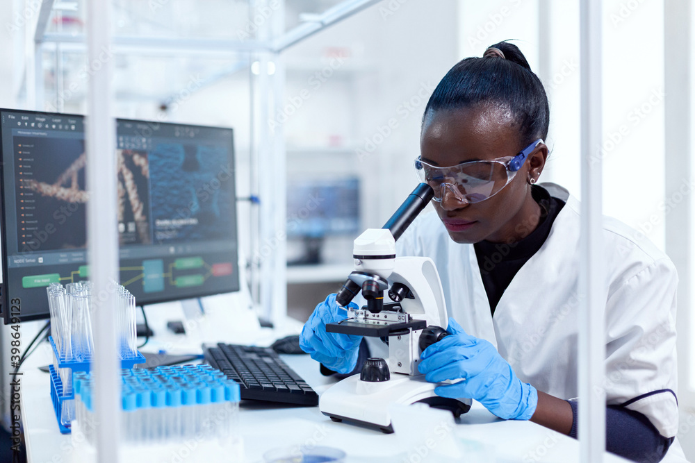 African doctor in pharmacology looking for sign of patoloy in patient ...