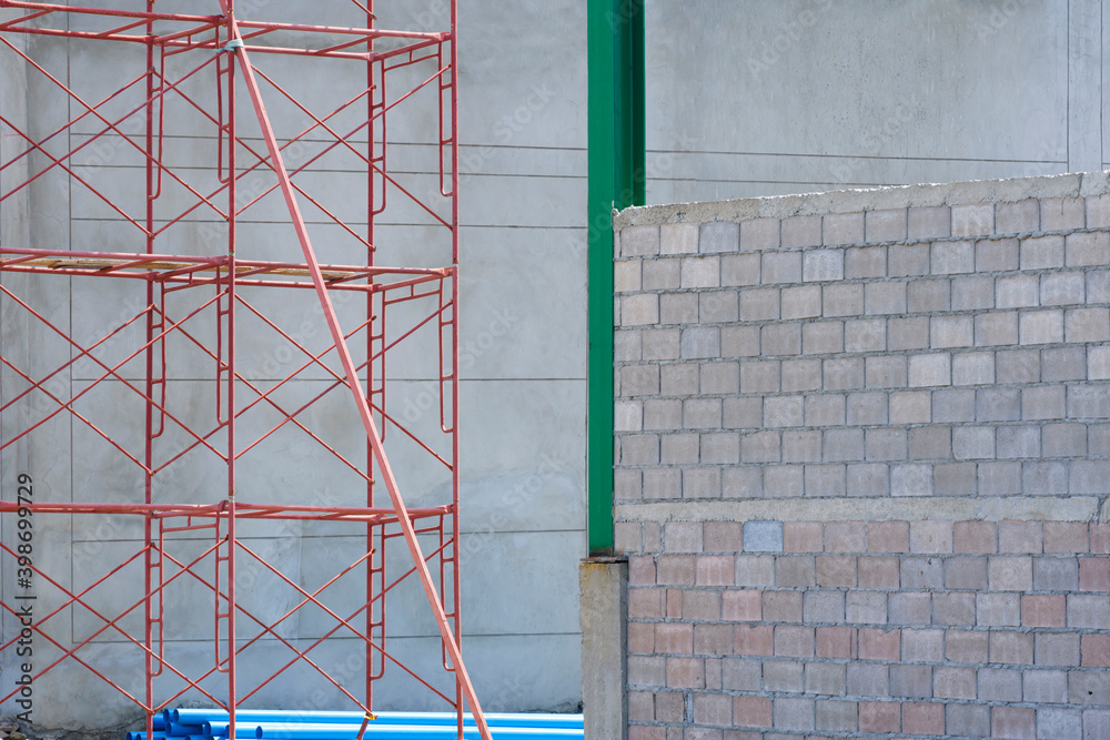 Perspective side view of red scaffolding with blue water pipes outside ...