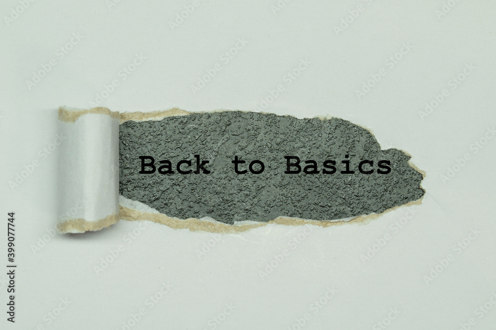 Text Back to Basics appearing behind torn white paper. top view of open ...