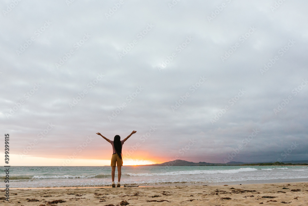 Girl enjoying sunset on the beach Stock Photo | Adobe Stock