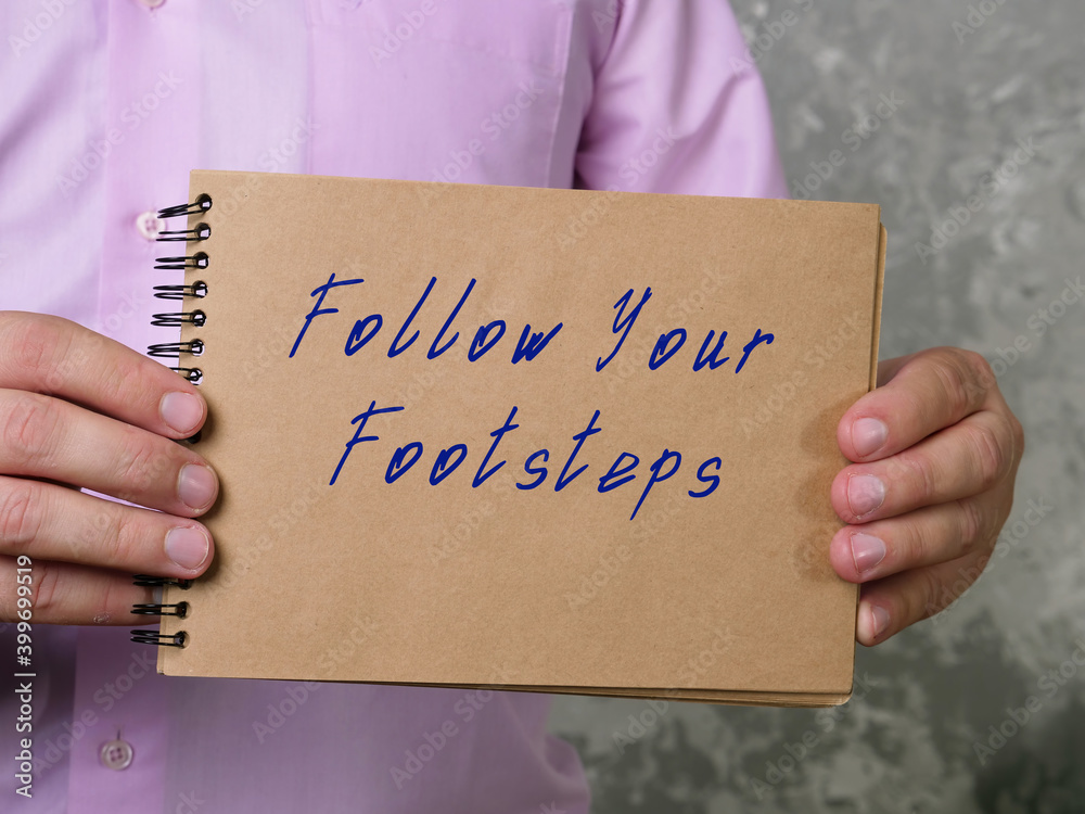 Motivational concept meaning Follow Your Footsteps with sign on the ...