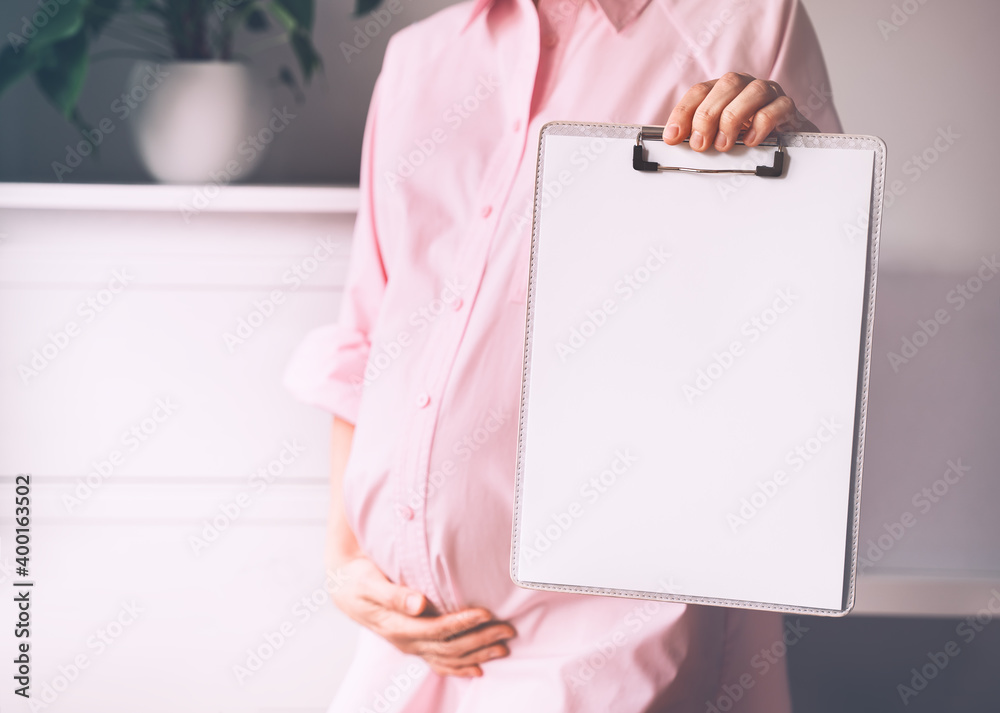 Pregnant woman with empty white paper as medical card, agreement blank ...