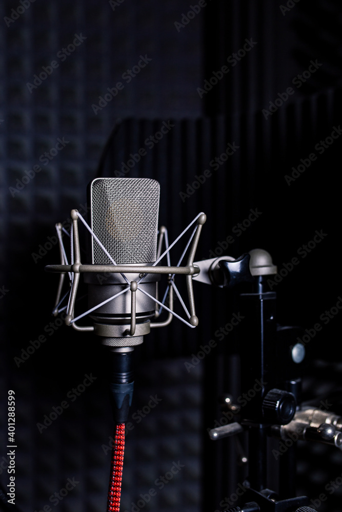 Contemporary metal microphone with wire placed on background of ...